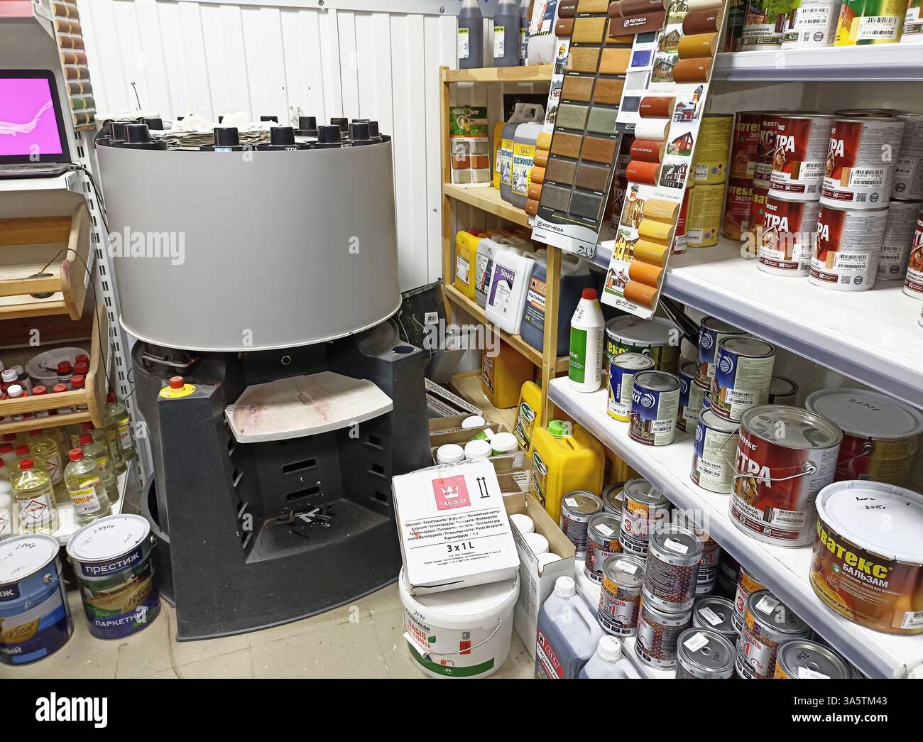 Paint shop interior with mixer machine and various coloring products ...