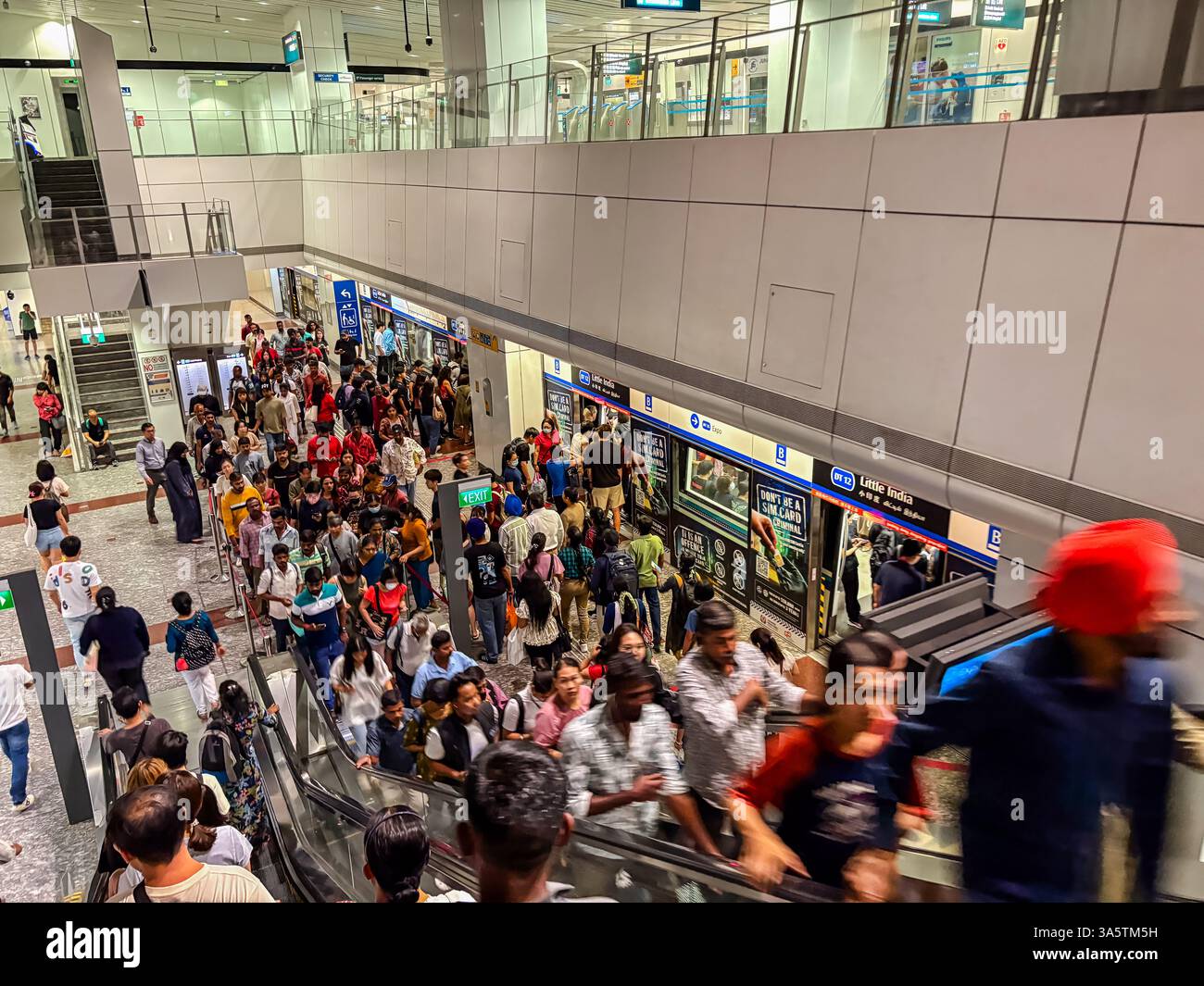 A crowded Singapore MRT (mass rapid transit) train station in Singapore ...