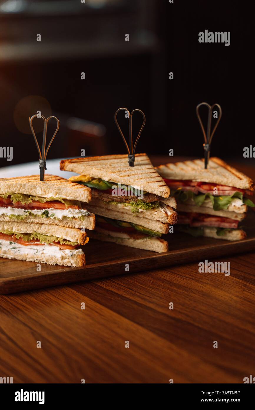 Different types of triangle sandwiches with skewers grilled on the ...