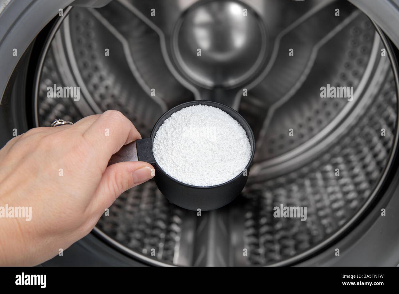 Cleaning washing machine drum with Citric acid. Person hand holding ...