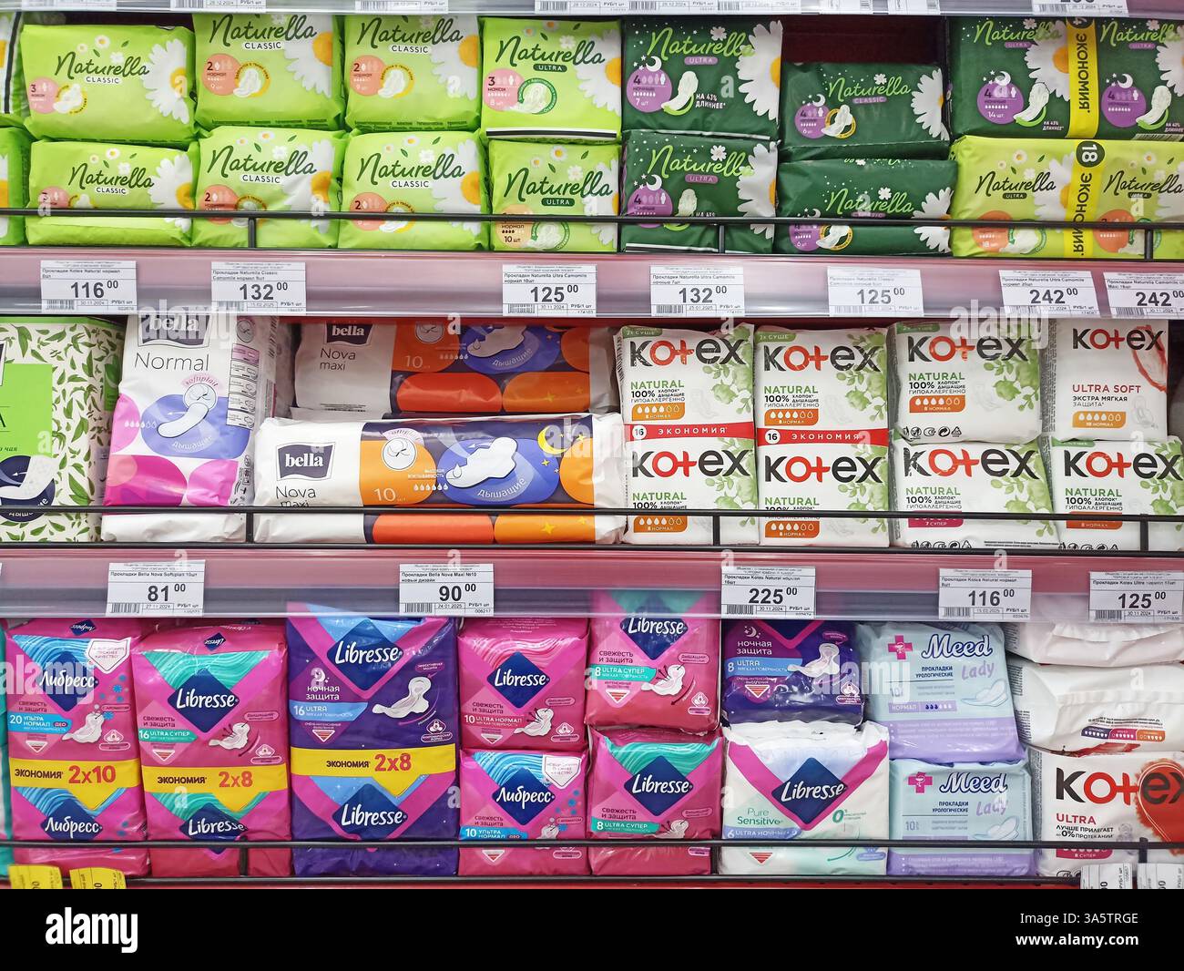 Assorted feminine hygiene products on store shelf with various brands ...