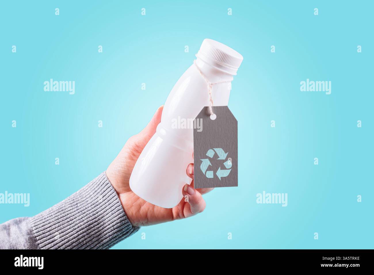 Reusable plastic bottle with recycling label against blue background ...