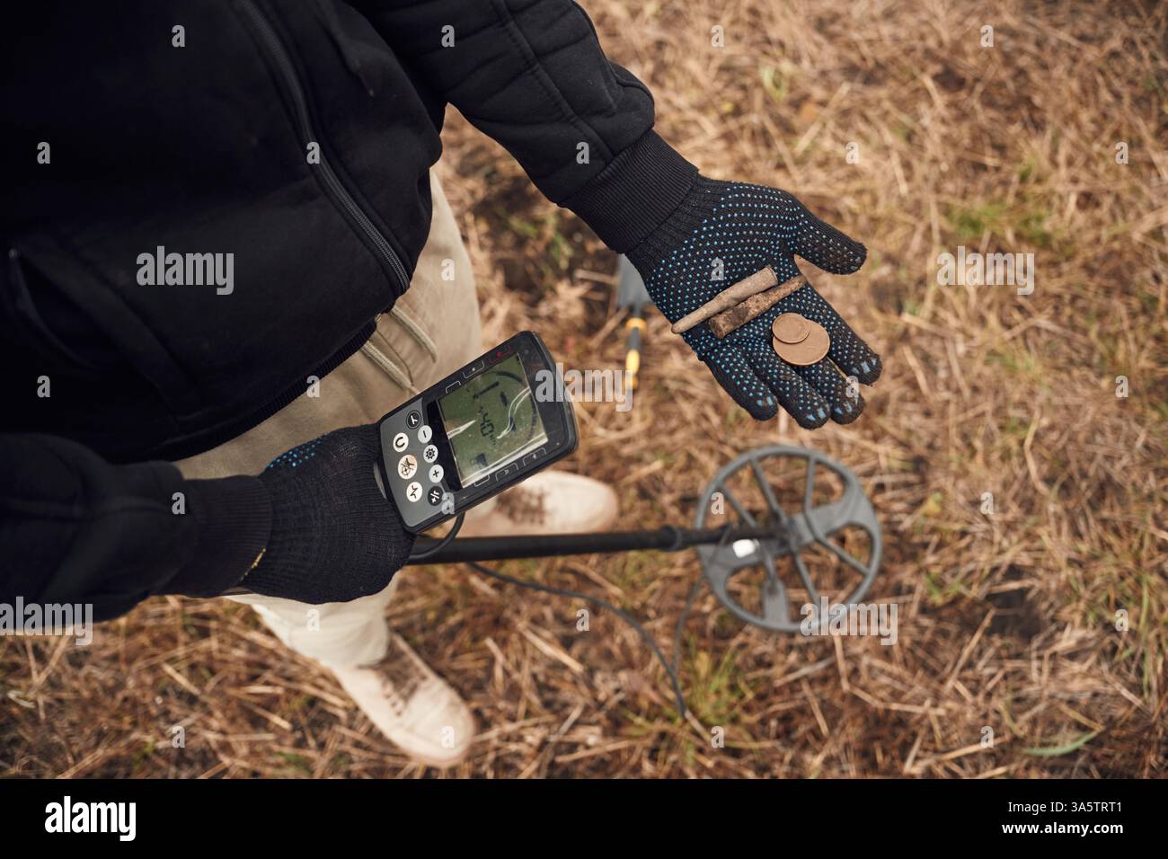 Old bullets and coin. Man is with metal detector in the field Stock ...