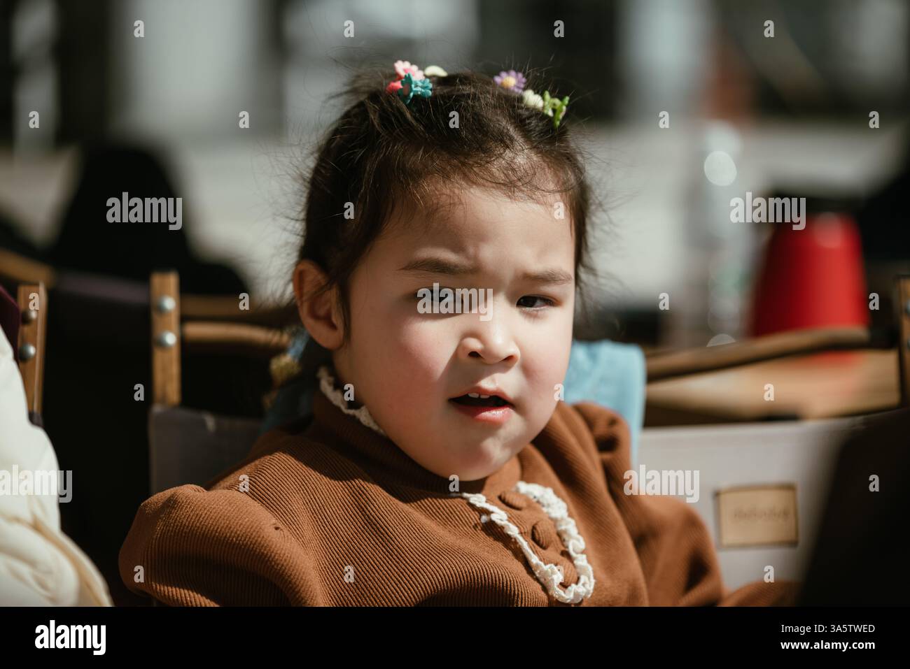 Portrait of a small, beautiful, cheerful and smiling multiracial girl ...