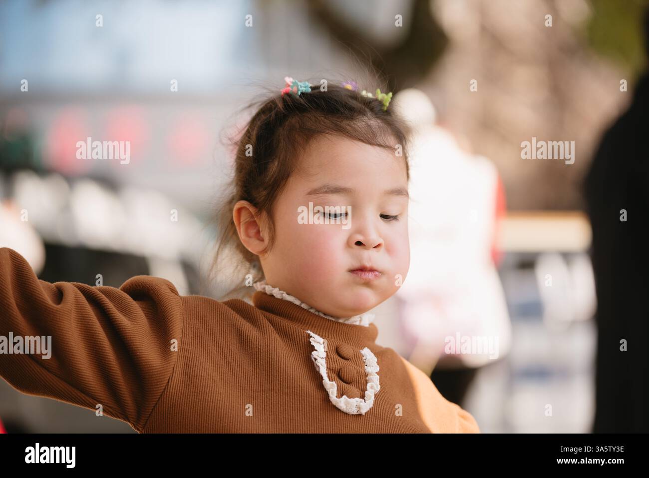 Portrait of a small, beautiful, cheerful and smiling multiracial girl ...