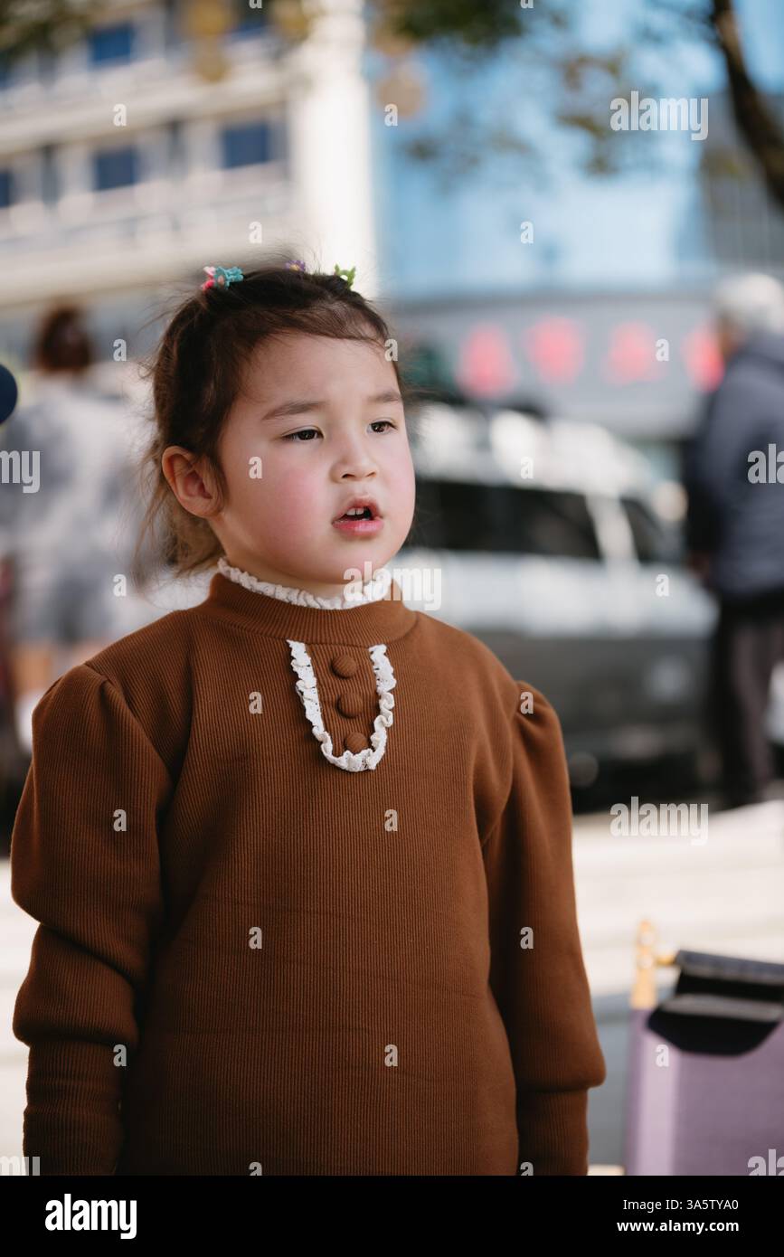 Portrait of a small, beautiful, cheerful and smiling multiracial girl ...