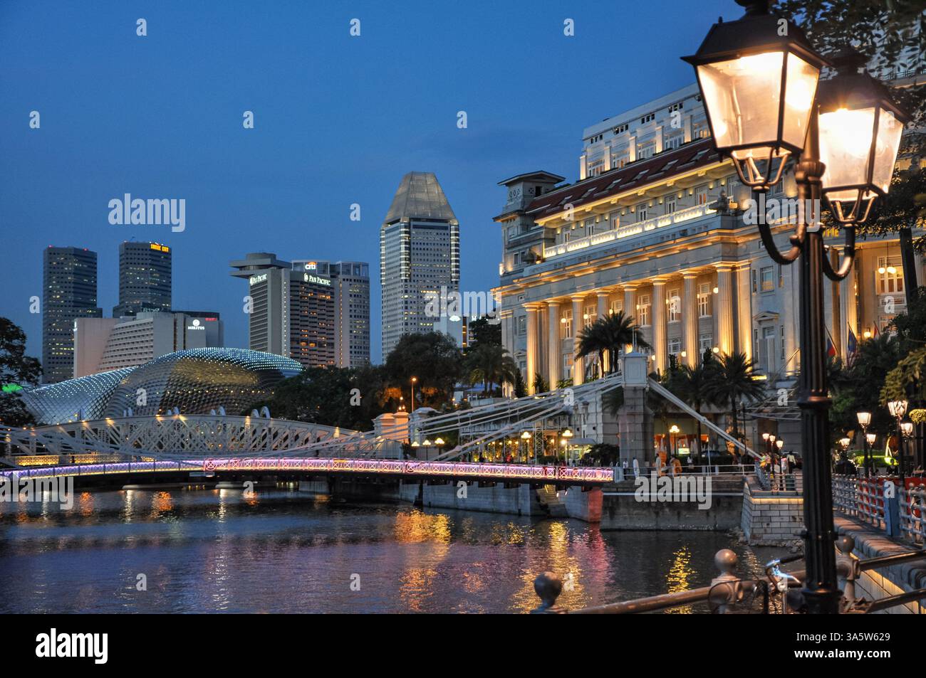 Singapore, Singapore - May 8, 2009: The evening skyline glows with ...