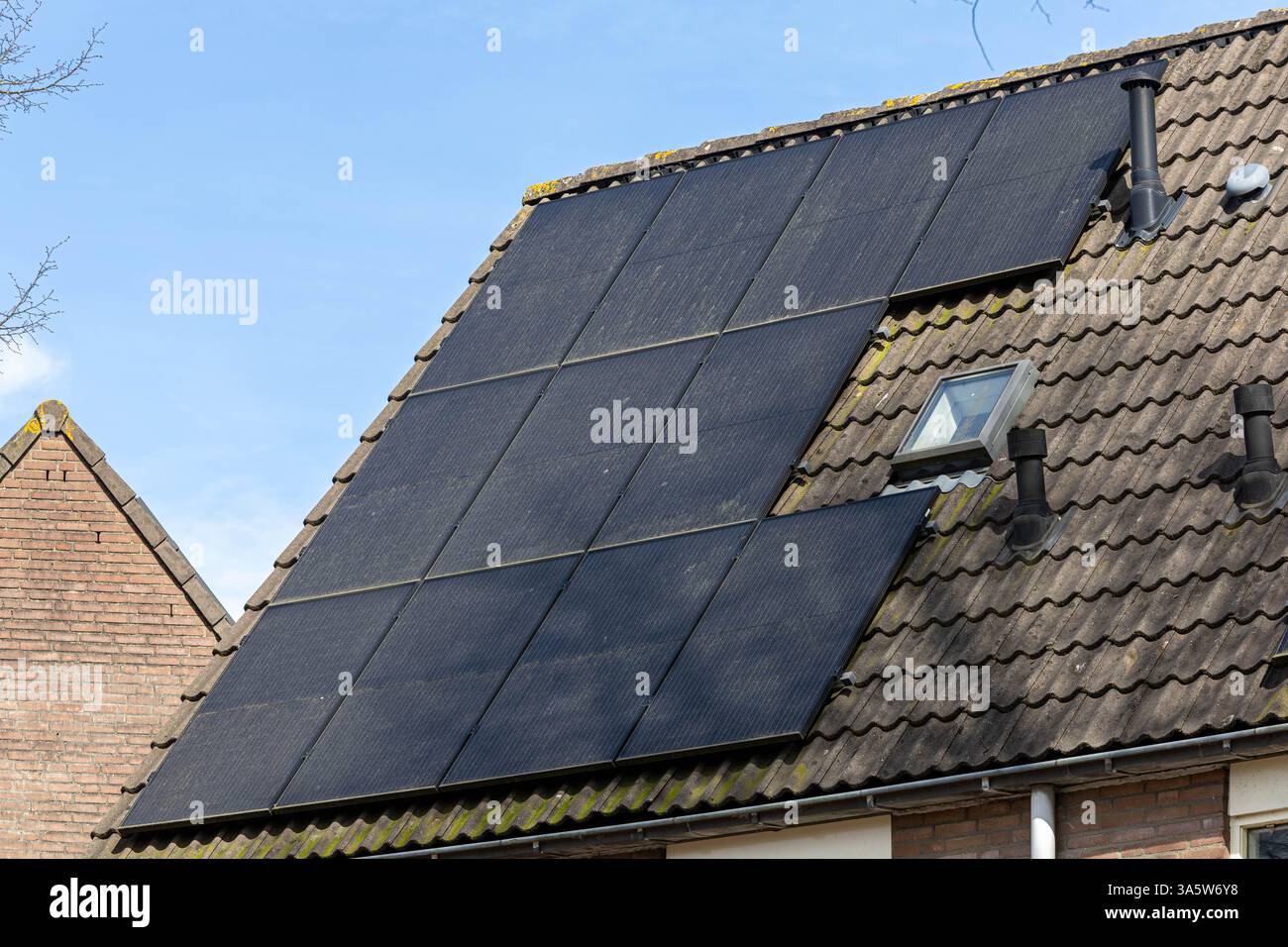 Dirty solar panels on a family house integrated on the roof. View of ...