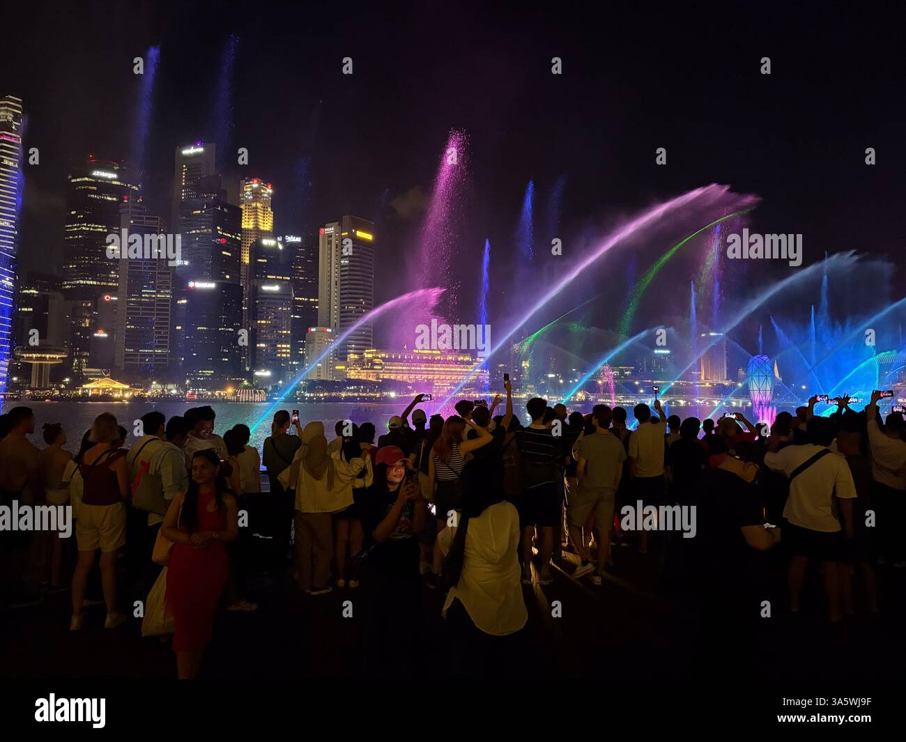 Crowd watches the Spectra light and water show along the Marina Bay ...