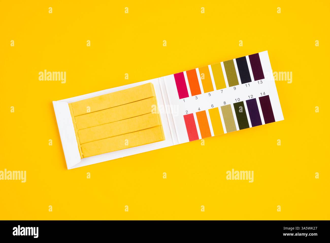 Universal indicator paper with acidic testing on yellow background ...