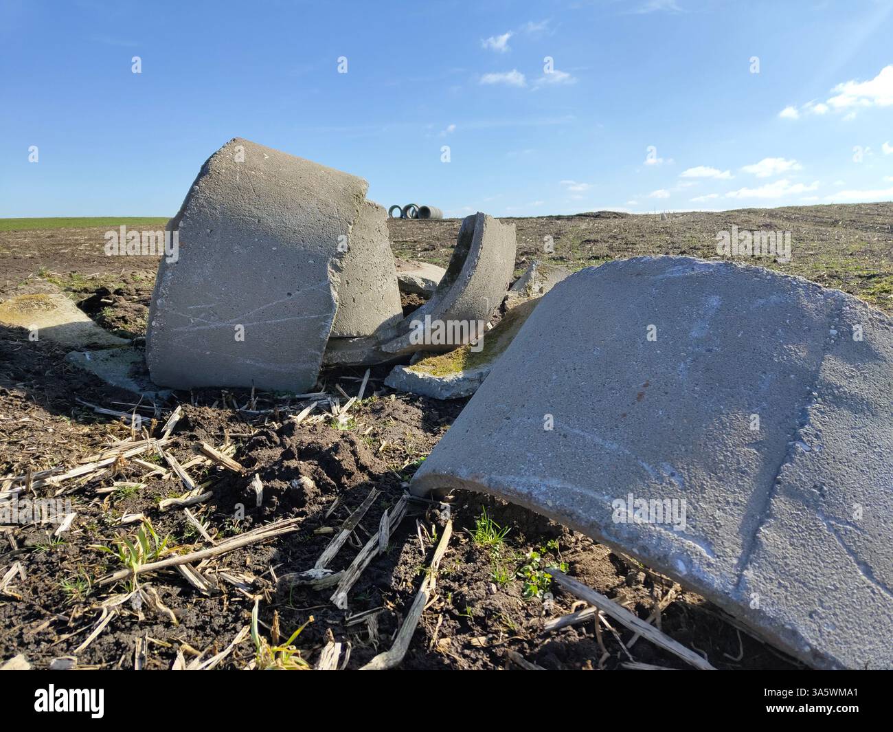 Broken concrete pipes in a field with clear blue sky background Stock ...