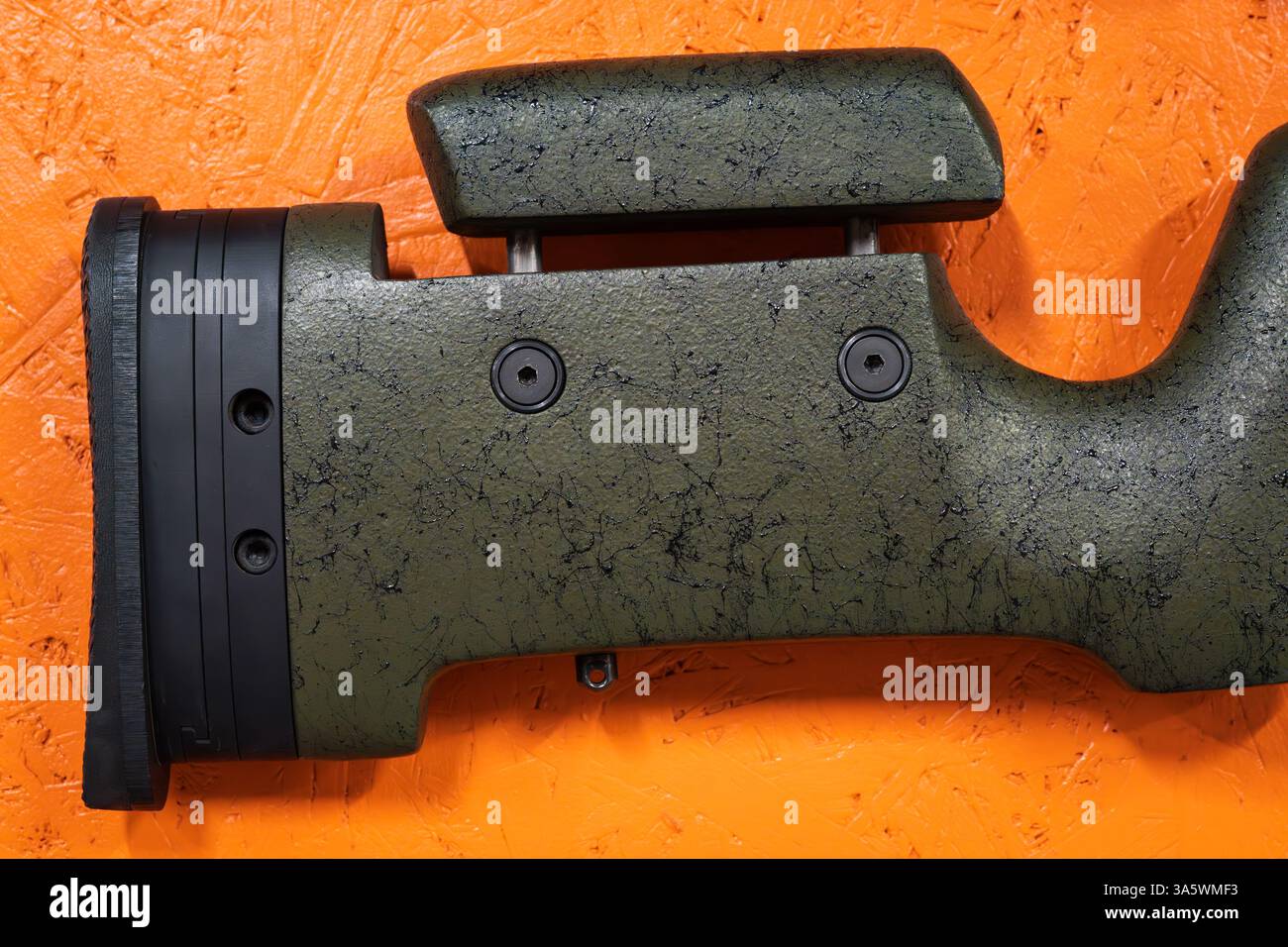 An example of a sniper rifle on an orange background, close-up photo ...
