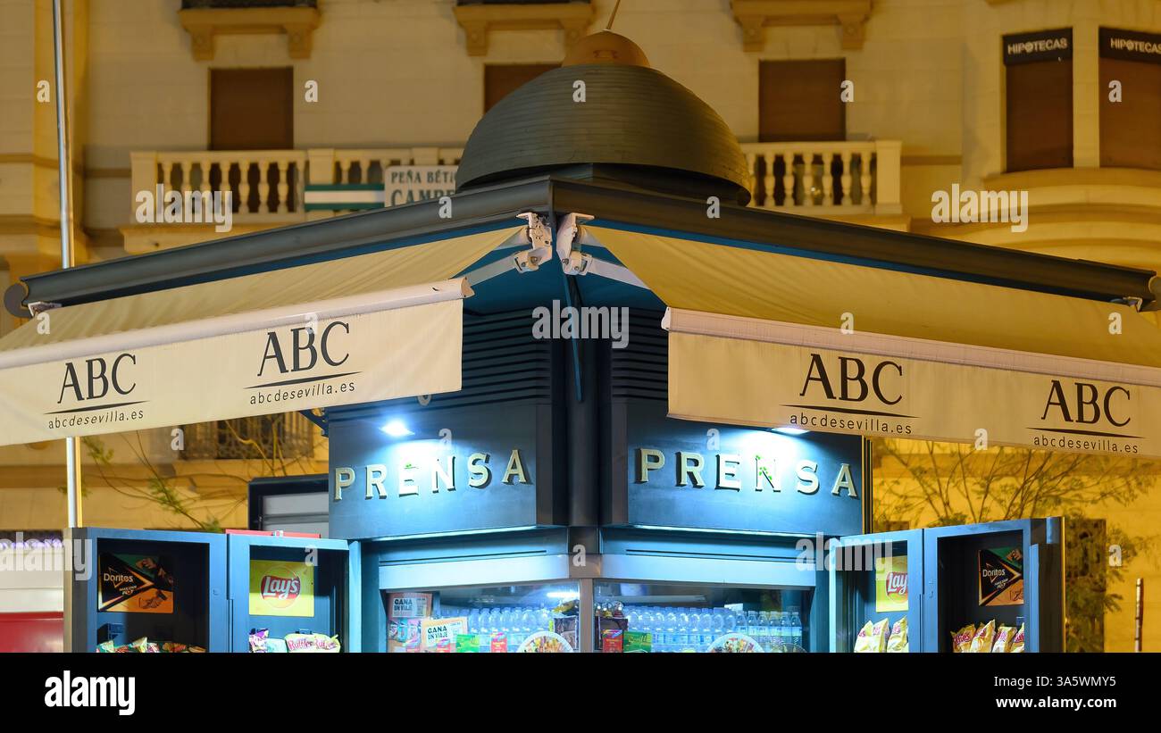 Media kiosk with the illuminated letters ABC at night Stock Photo - Alamy
