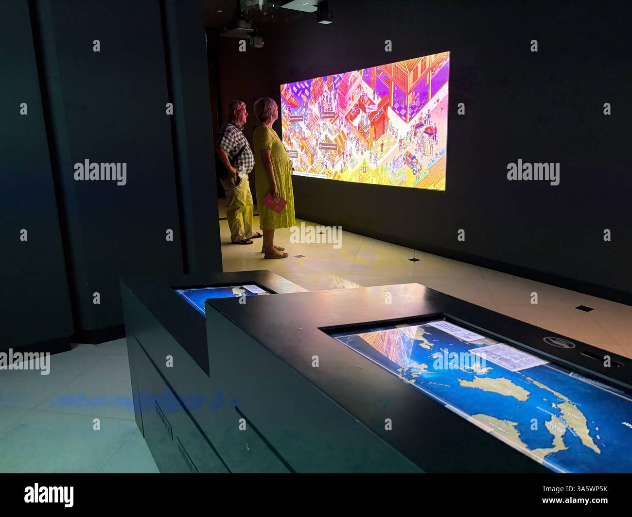 Visitors looking at a colourful city map at the Peranakan Museum in ...