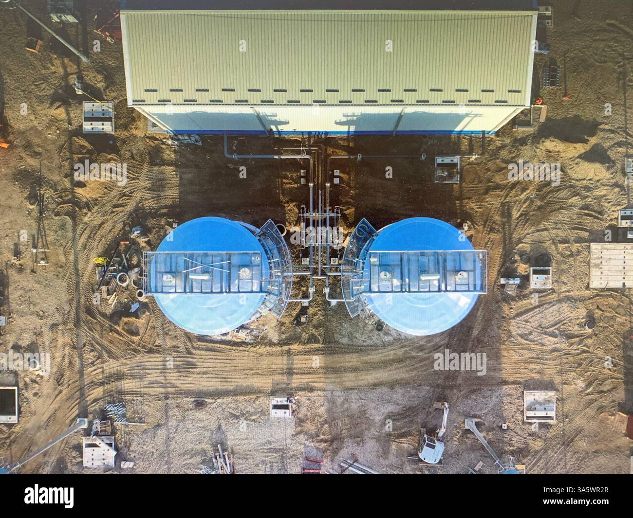 Aerial view of an industrial facility under construction featuring two ...