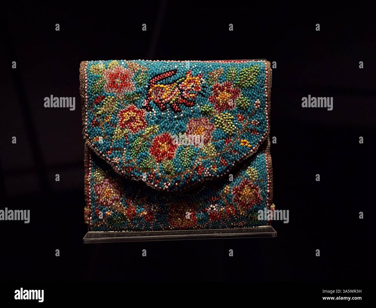 A Peranakan beaded purse with floral designs, intricate beadwork, and a ...