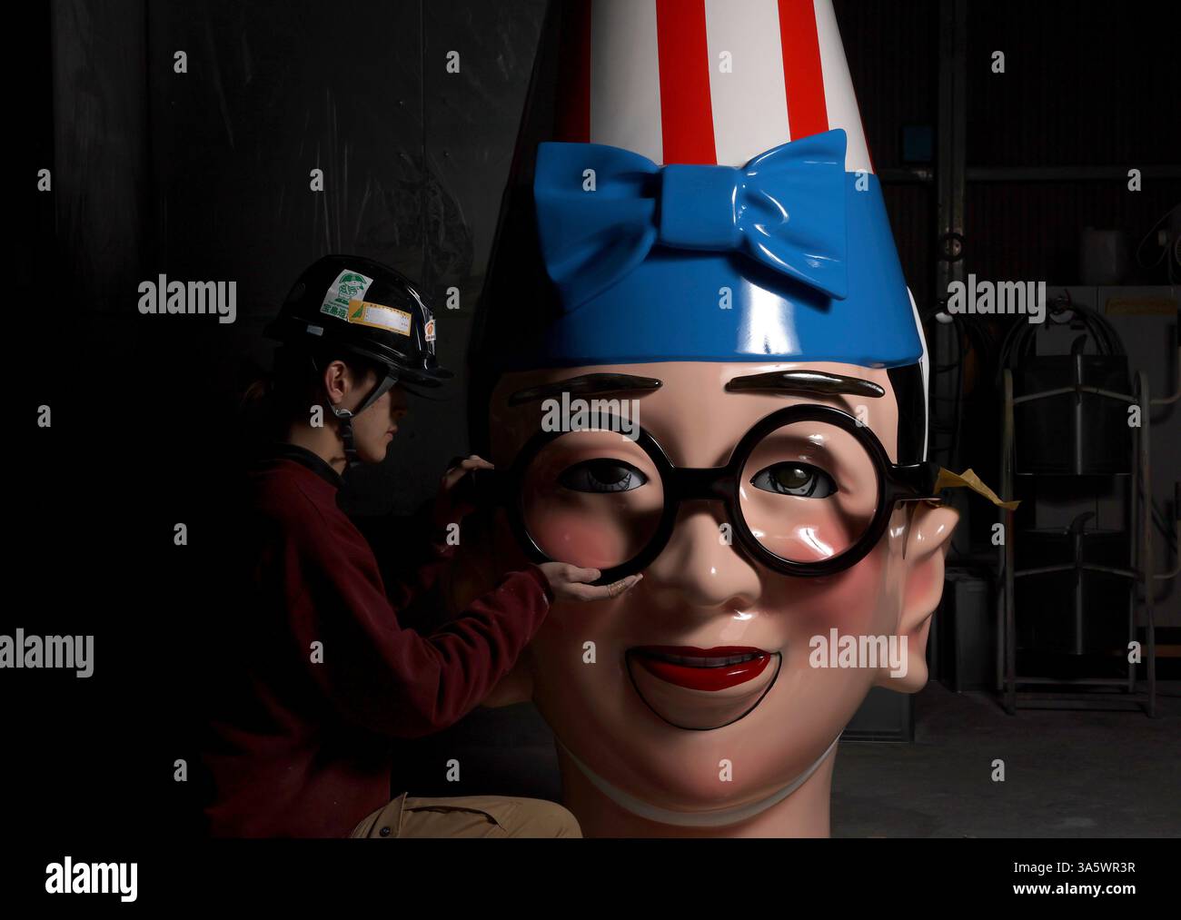 A three-dimensional "Kuidaore Taro" signboard is carefully crafted to ...