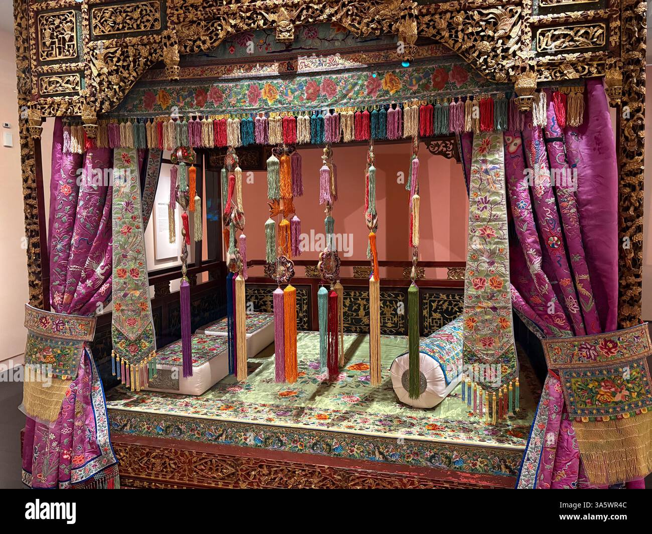 Intricate Chinese wedding bed in Singapore museum. The bed is draped ...