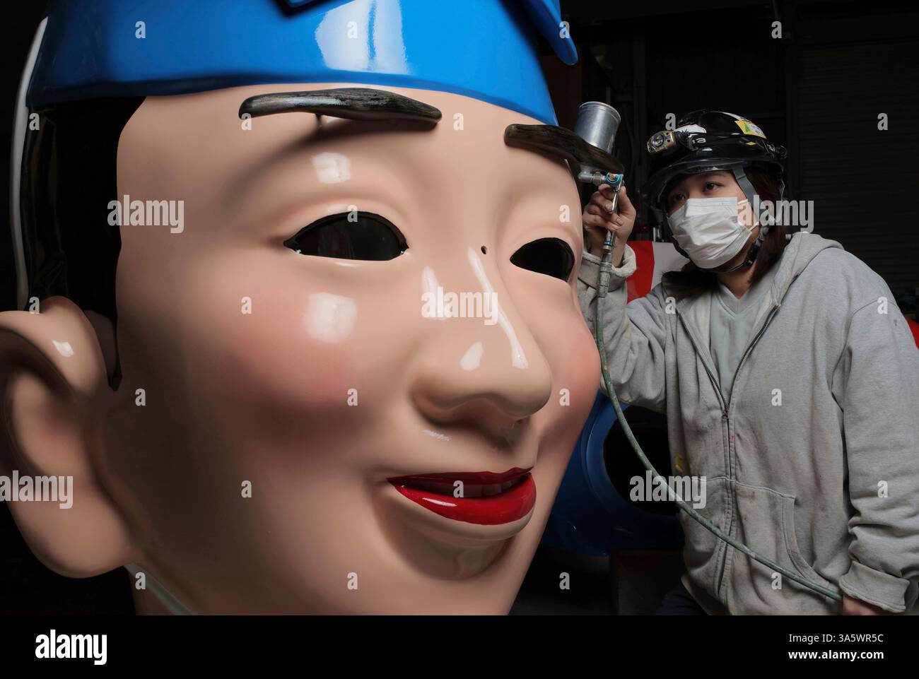 A three-dimensional "Kuidaore Taro" signboard is carefully crafted to ...
