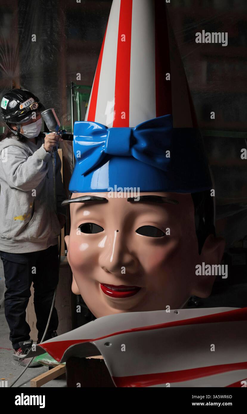 A three-dimensional "Kuidaore Taro" signboard is carefully crafted to ...