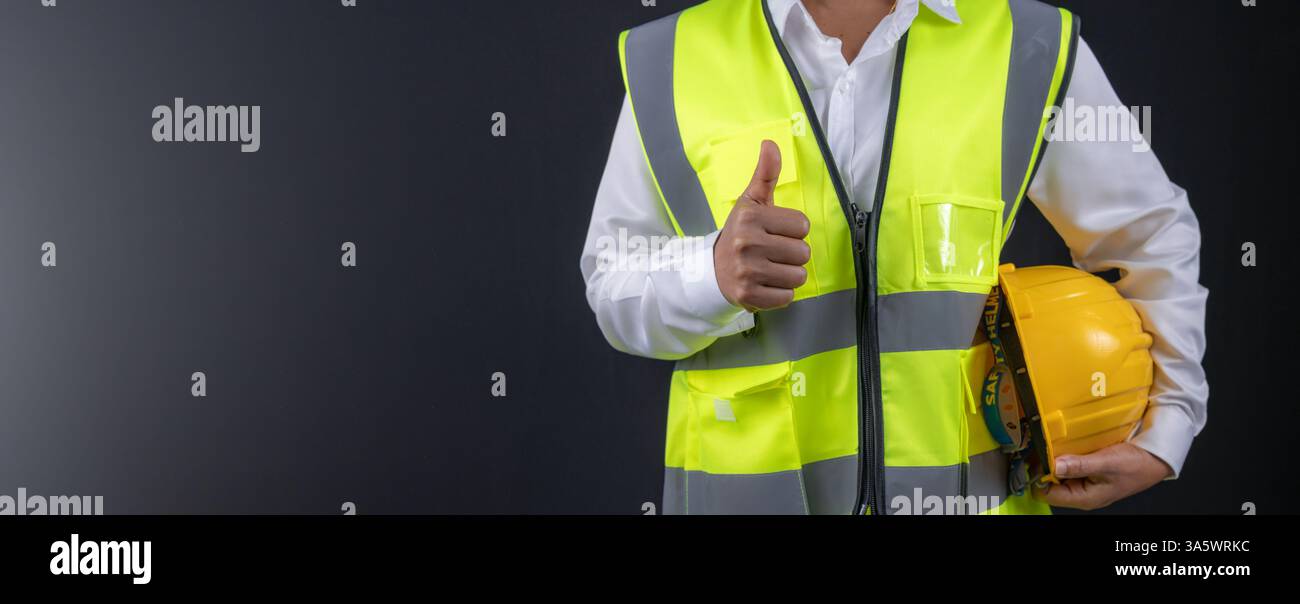 Civil engineer architect standing holding a safety helmet on dark ...