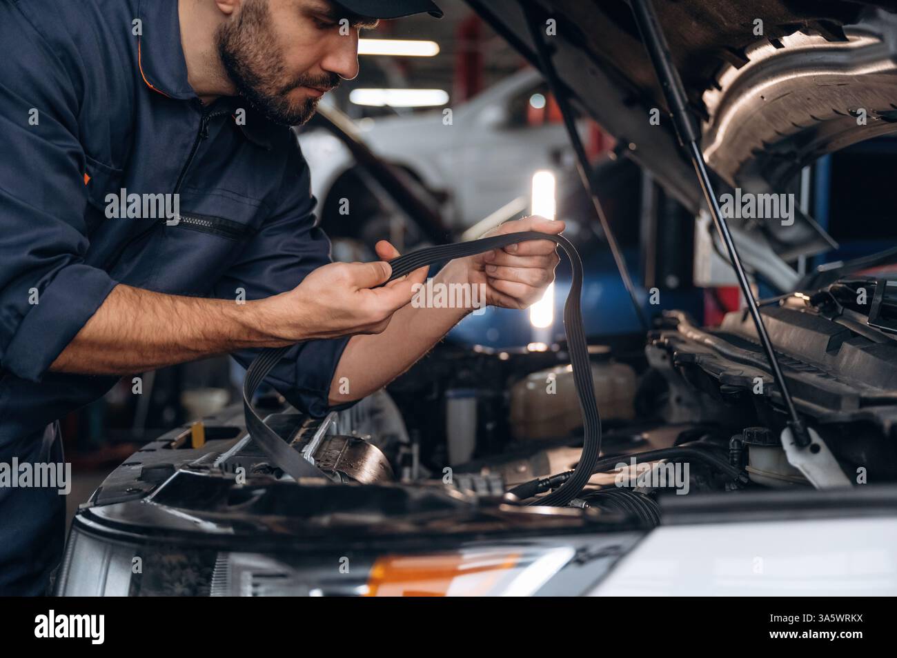 Cable installation. Mechanic working in a car service station Stock ...