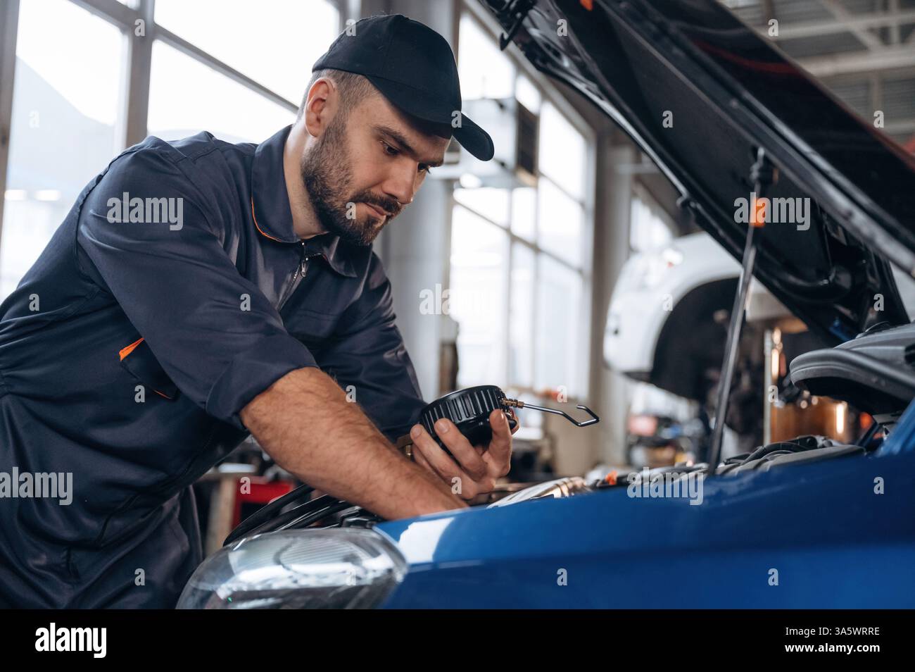 Focused at work. Mechanic is in a car service station Stock Photo - Alamy