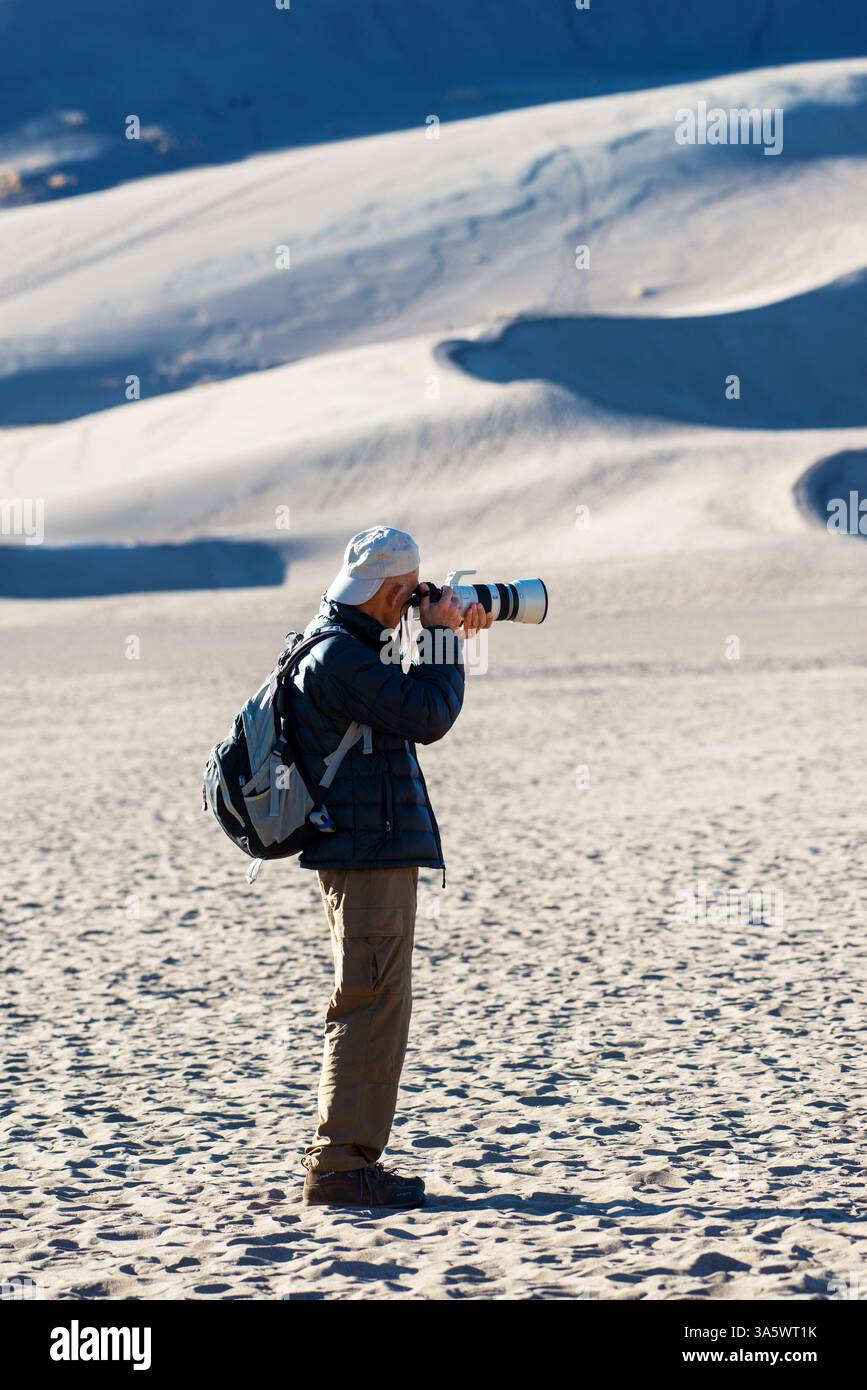 Photographer uses telephoto camera hi-res stock photography and images ...