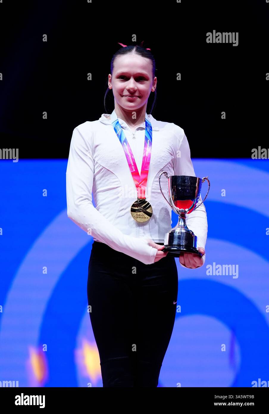 Lexi Holmes with the gold medal for the Junior Women's Apparatus Beam ...
