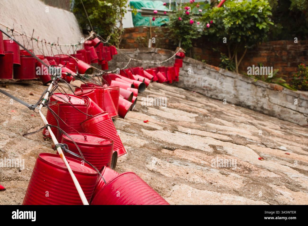 Red tin cans hung across a slope in Tai O, Hong Kong Stock Photo - Alamy