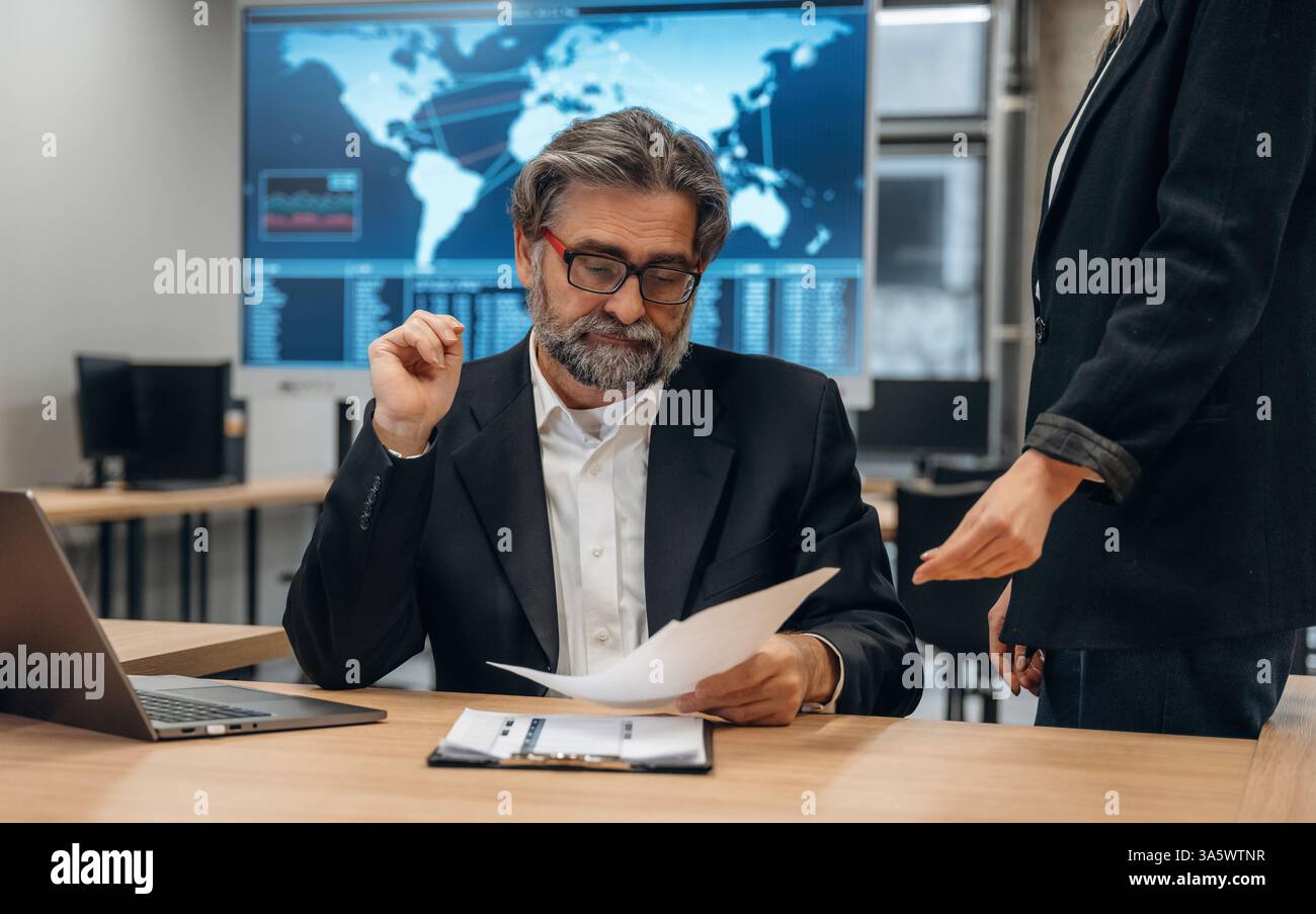 More paper work, boring, tired. Senior man is in the office with ...