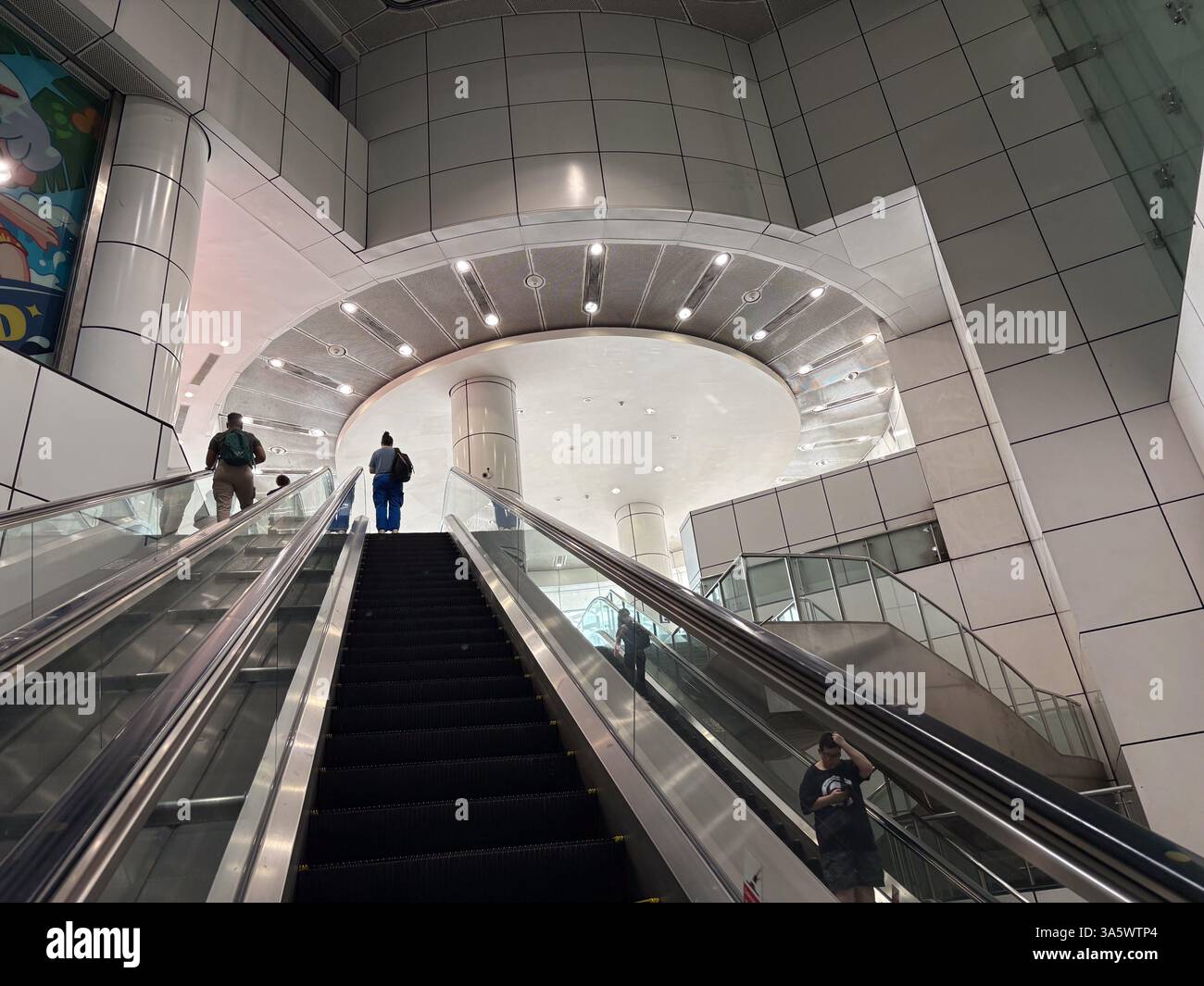 Escalator in Singapore expo mrt station. People ride the escalators ...