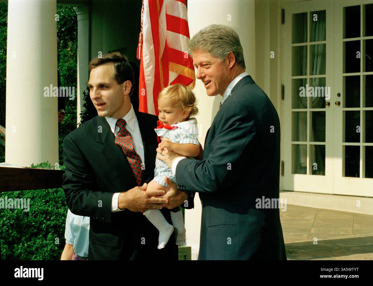 President Bill Clinton, right, and Judge Louis Freeh, left hold Freeh's ...