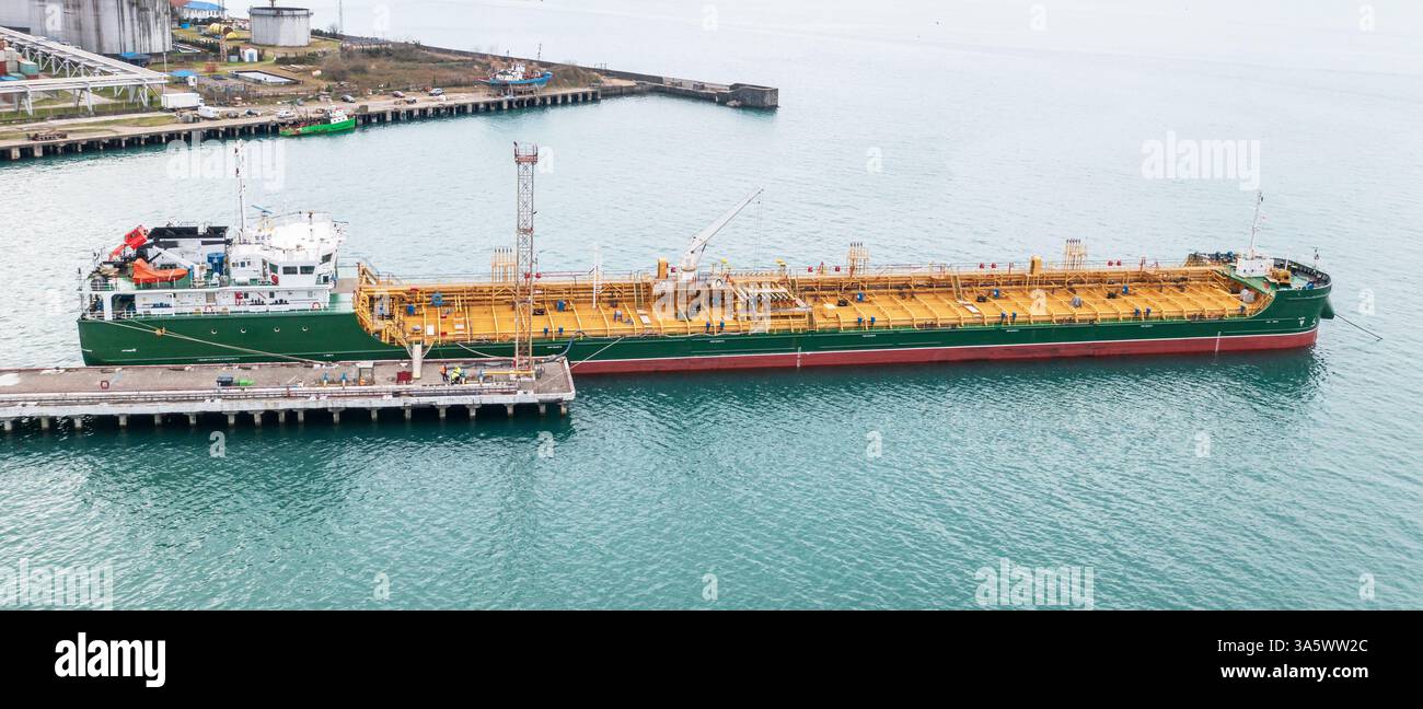 Large chemical tanker ship docked at industrial seaport terminal, used ...