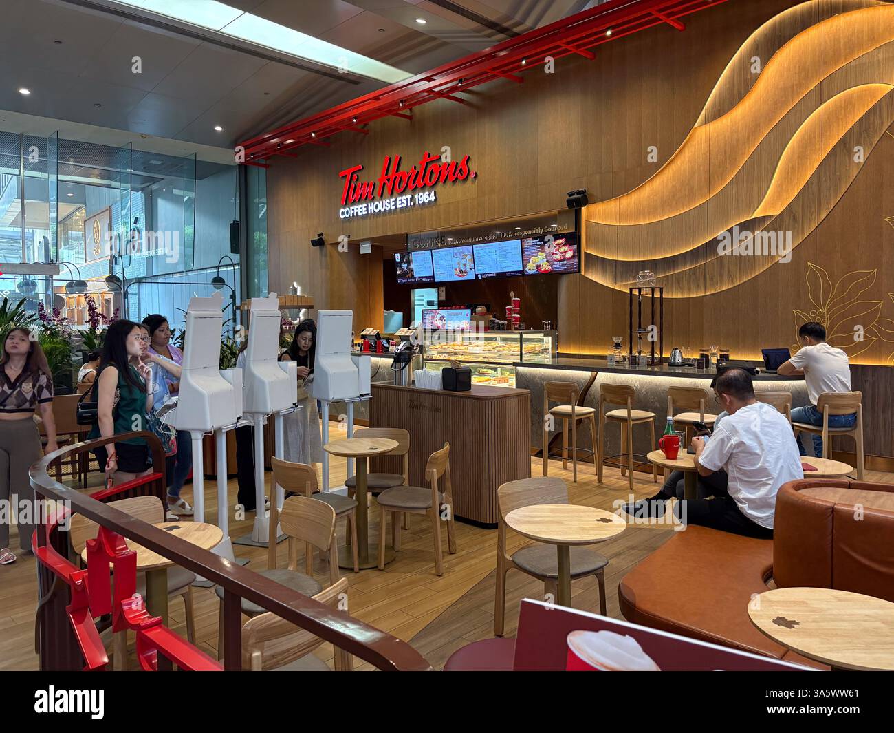 Tim Hortons at Raffles City Singapore, with patrons ordering, dining ...