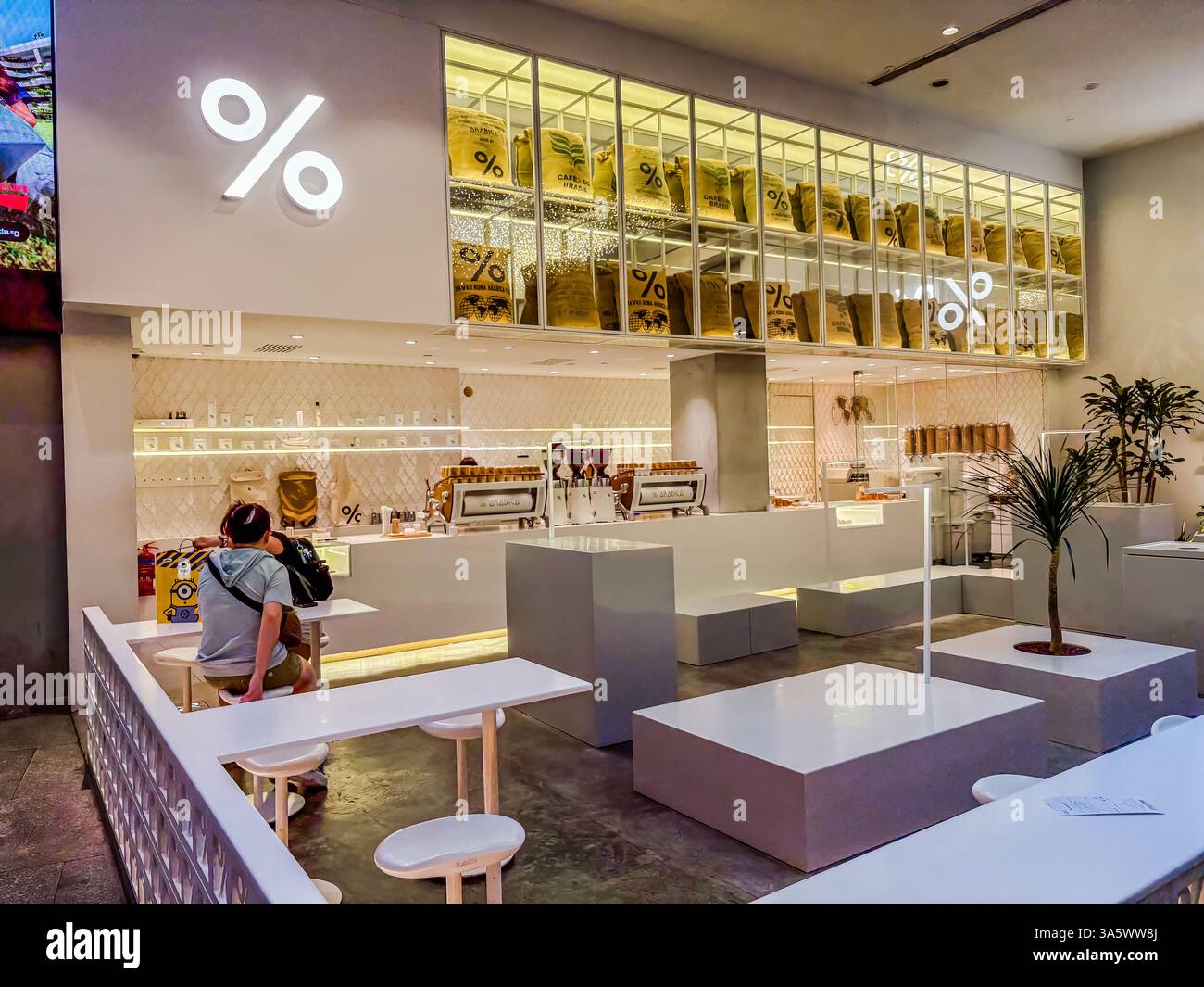 % Arabica coffee shop in Singapore. Clean white interior, coffee bags ...