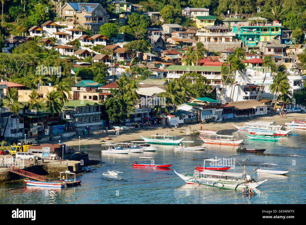Boats are moored in the main Sabang Bay of PUERTO GALERA, MINDORO ...