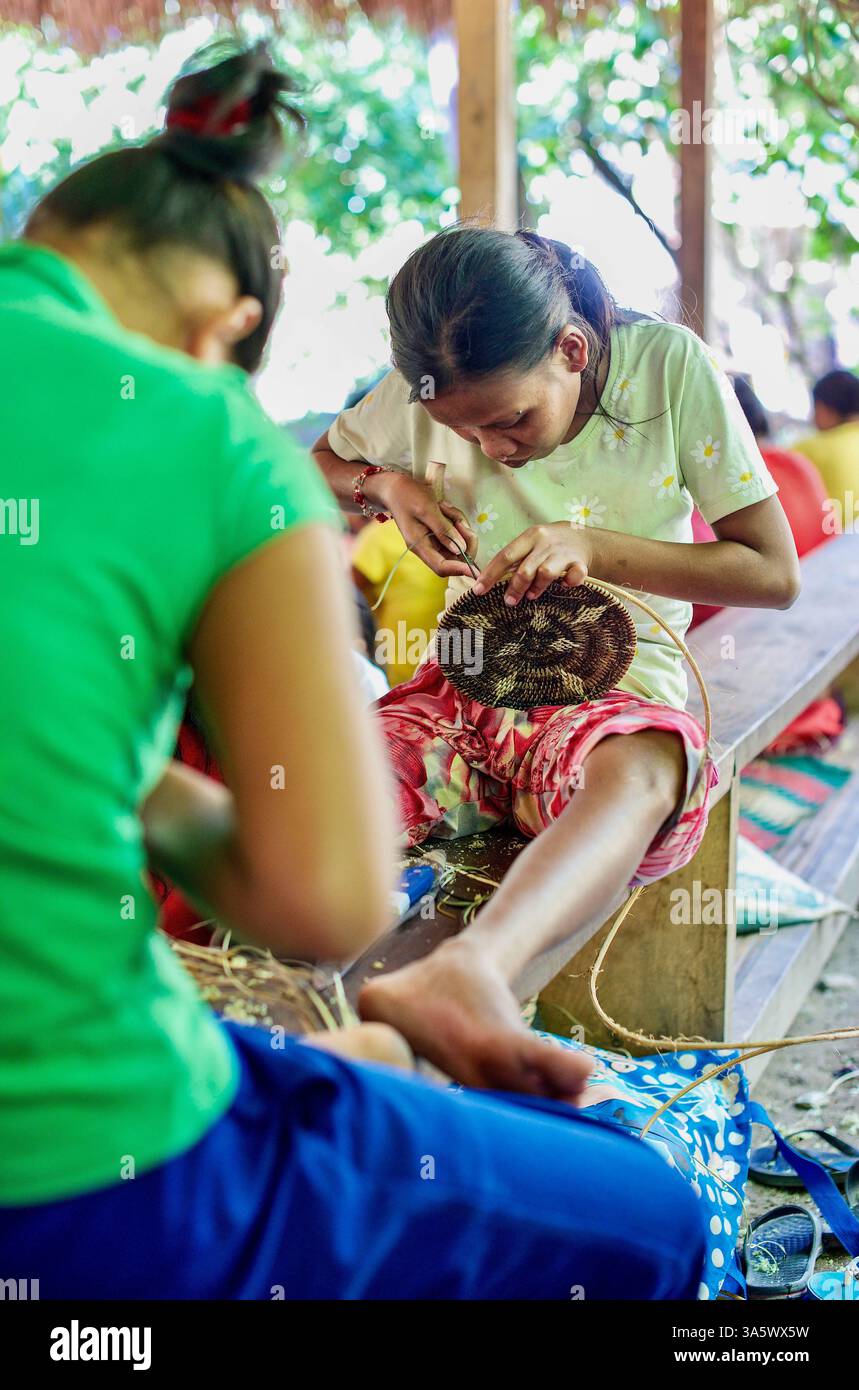 Members of the Iriya tribe, Mindoro’s indigenous people, weave baskets ...