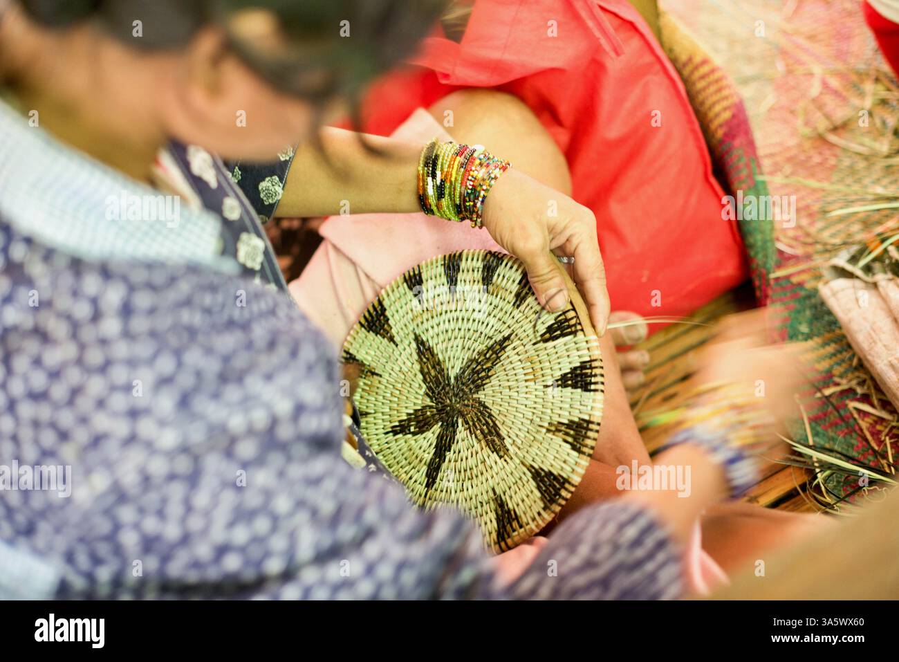 Members of the Iriya tribe, Mindoro’s indigenous people, weave baskets ...