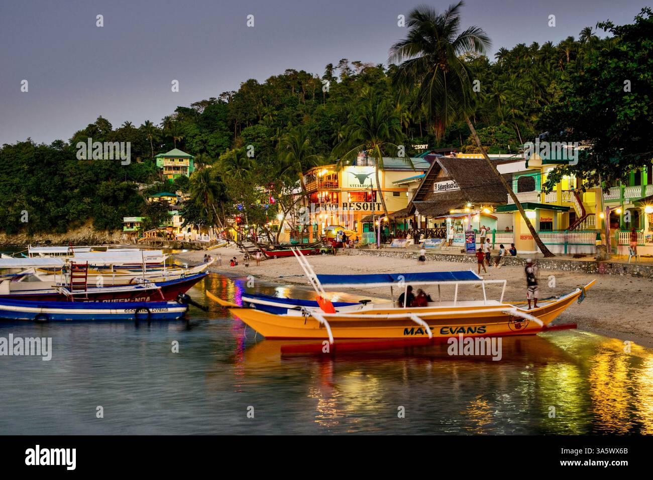 Boats are moored in the main Sabang Bay of PUERTO GALERA, on Mindoro ...