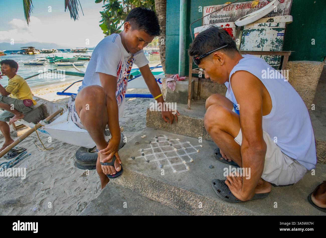 Local residents play a traditional game called Dama -- a kind of ...