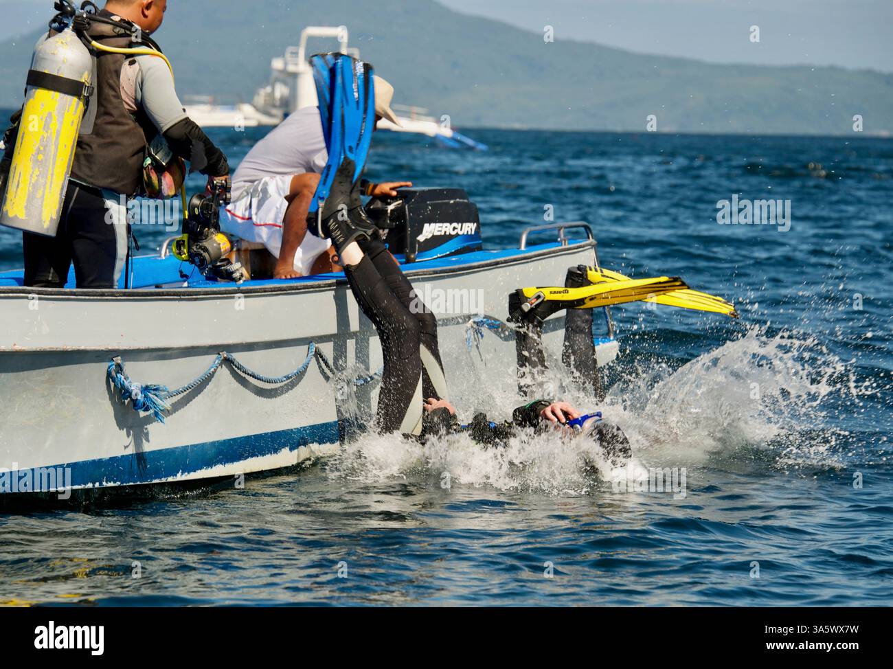 Divers enter the water prior to a dive in Puerto Galera, Mindoro Island ...
