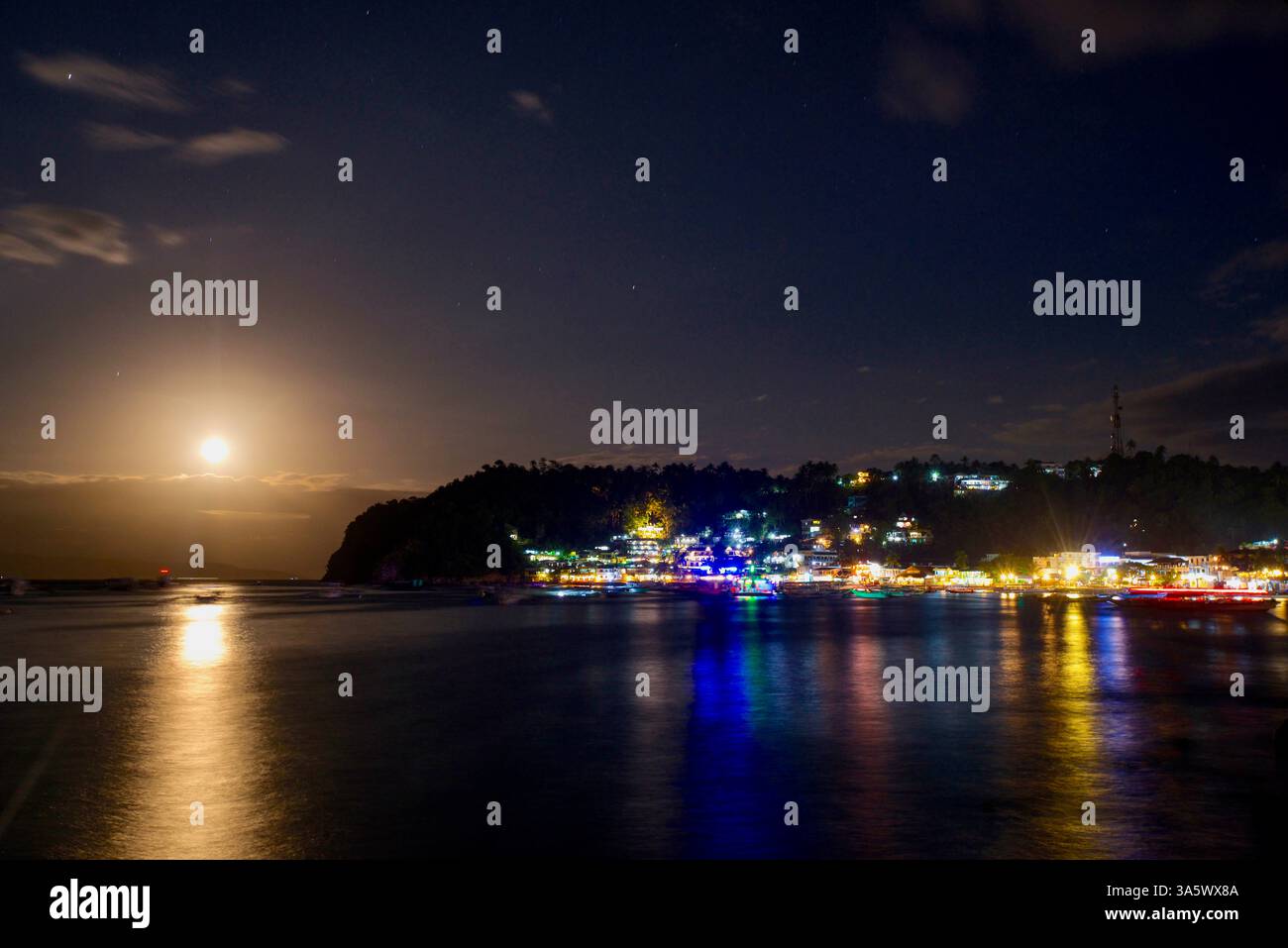The moon rises over Sabang Bay in Puerto Galera, Mindoro Island, the ...