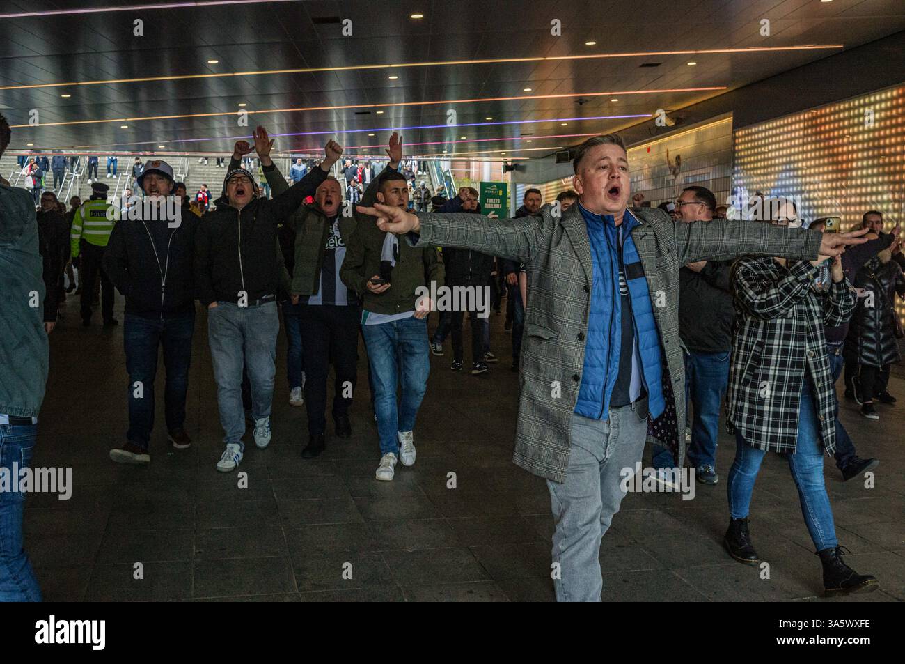 Newcastle United fans chant and sing as they walk down Wembley Way. On ...