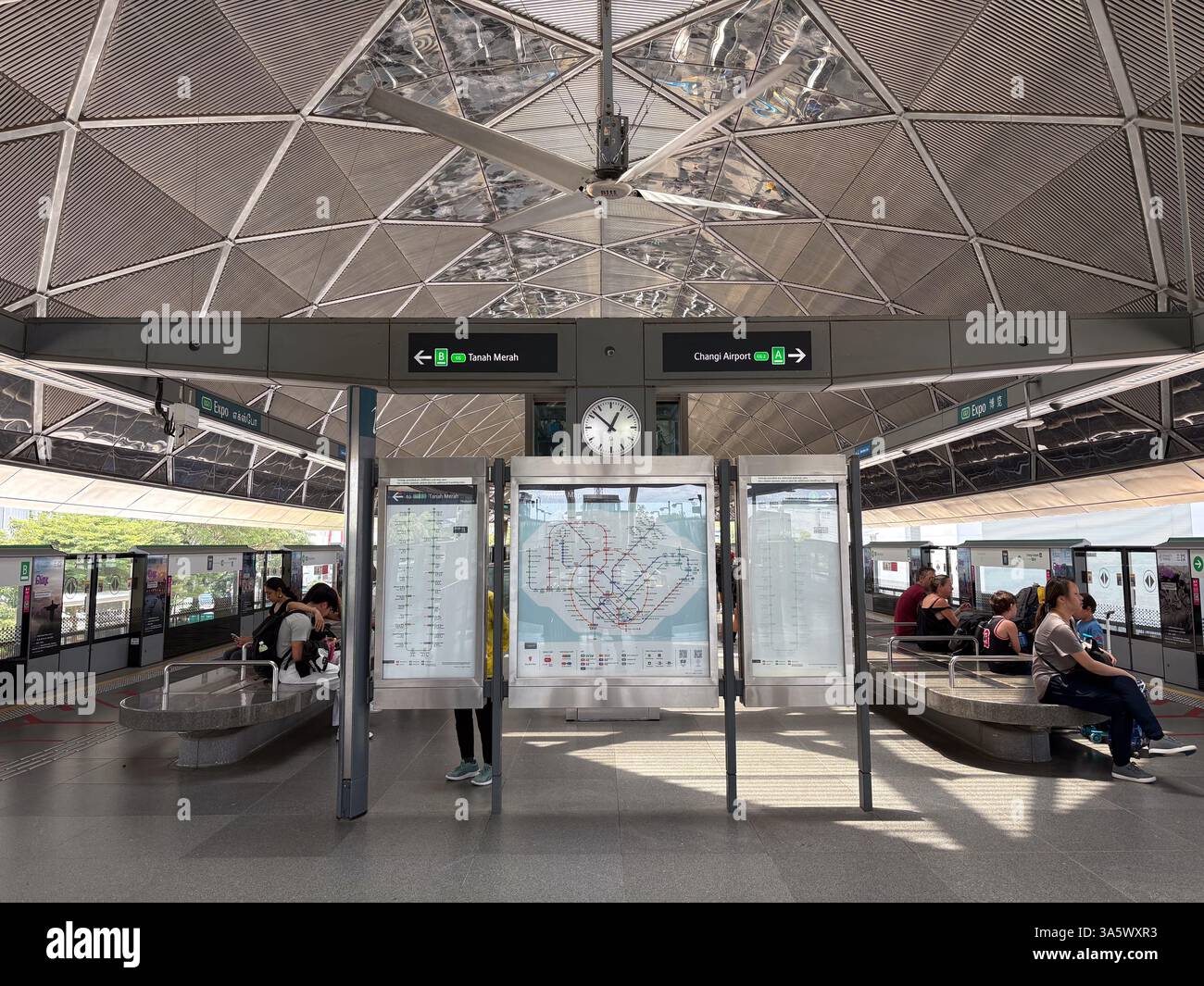 Expo Mrt Station in Singapore with commuters, signage and platform ...