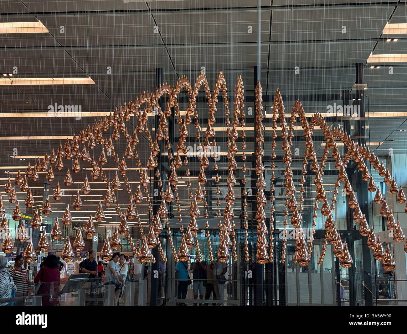 Kinetic Rain at Changi Airport. The art installation consists of hundreds of bronze droplets ...
