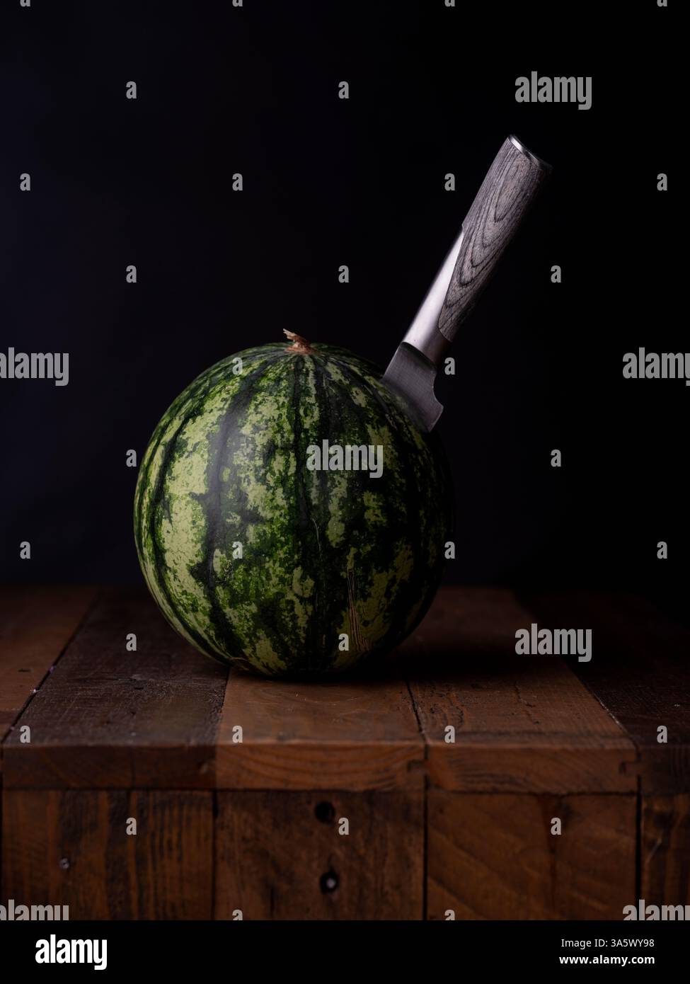 A captivating still life featuring a watermelon, beautifully lit by ...