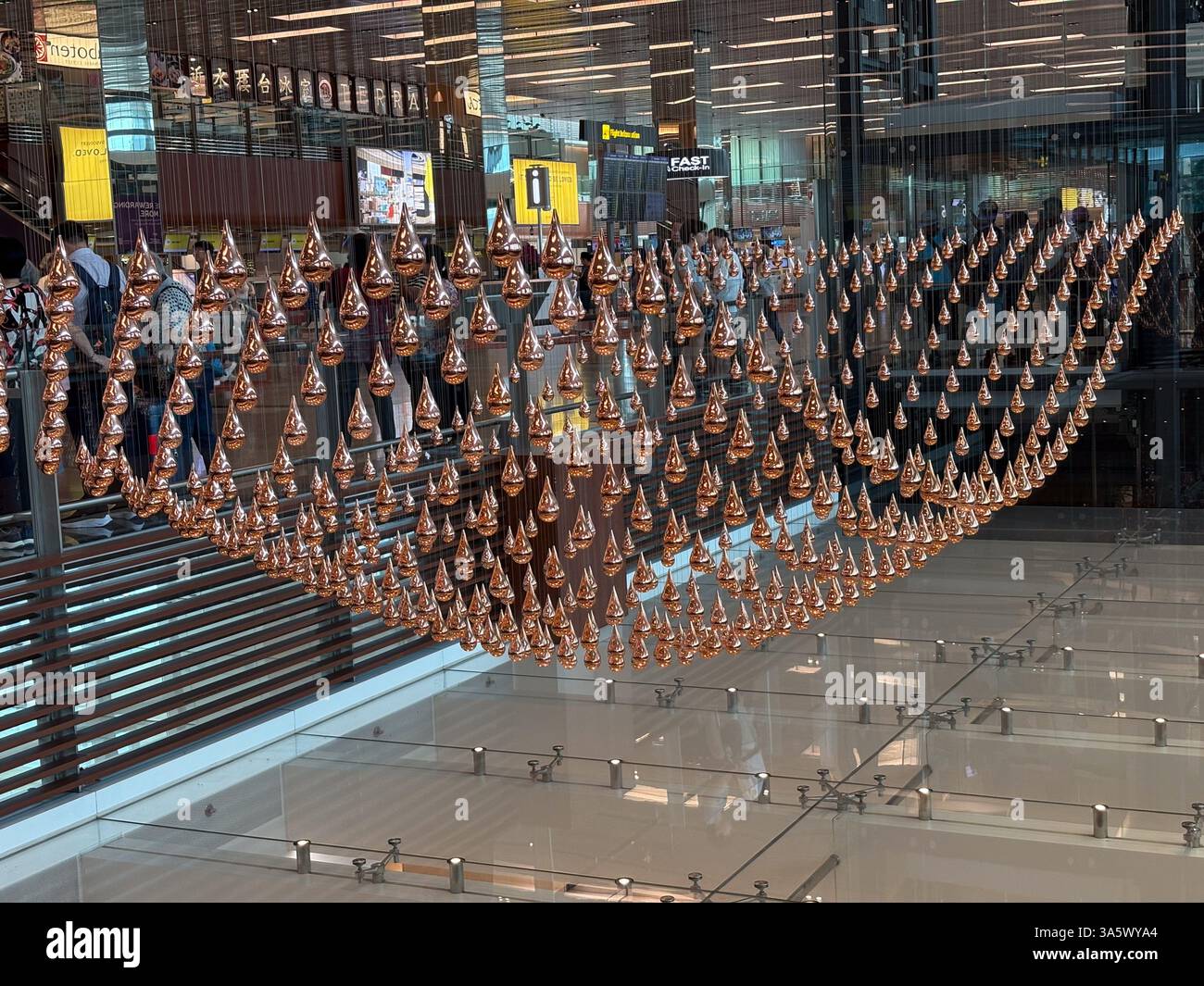 Kinetic Rain is an art installation at Singapore Changi Airport. Hundreds of bronze droplets ...