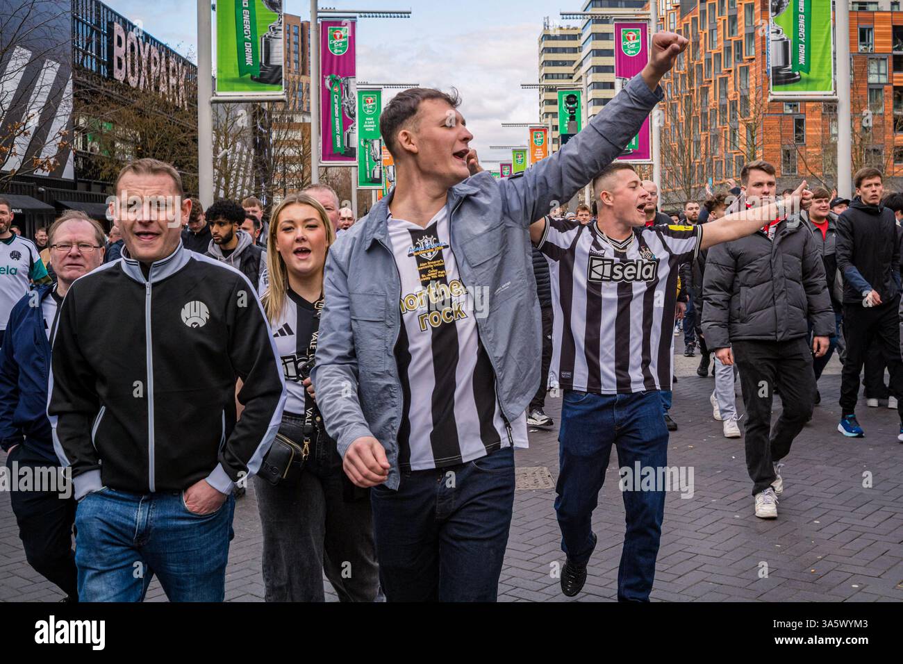 Newcastle United fans gesture and chant as they walk towards the ...