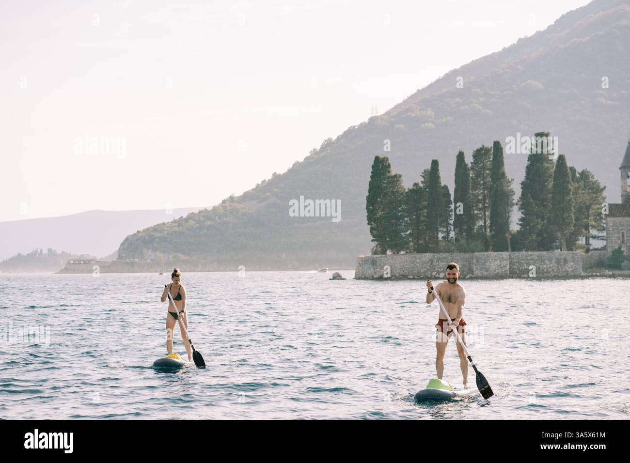 Sup surfers float on sea hi-res stock photography and images - Alamy